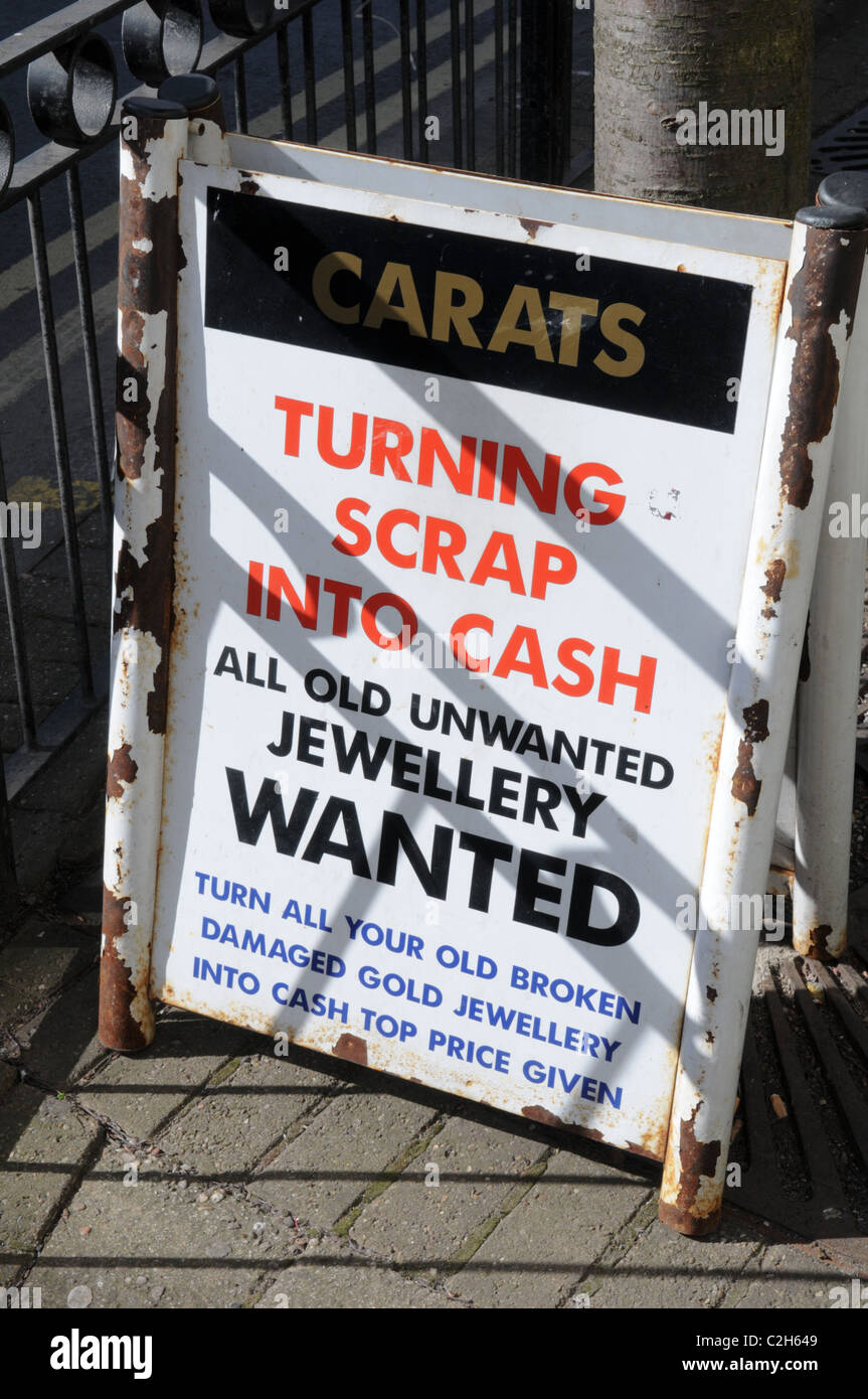 A rusty pavement sign for unwanted gold and scrap jewellery to sell for ...