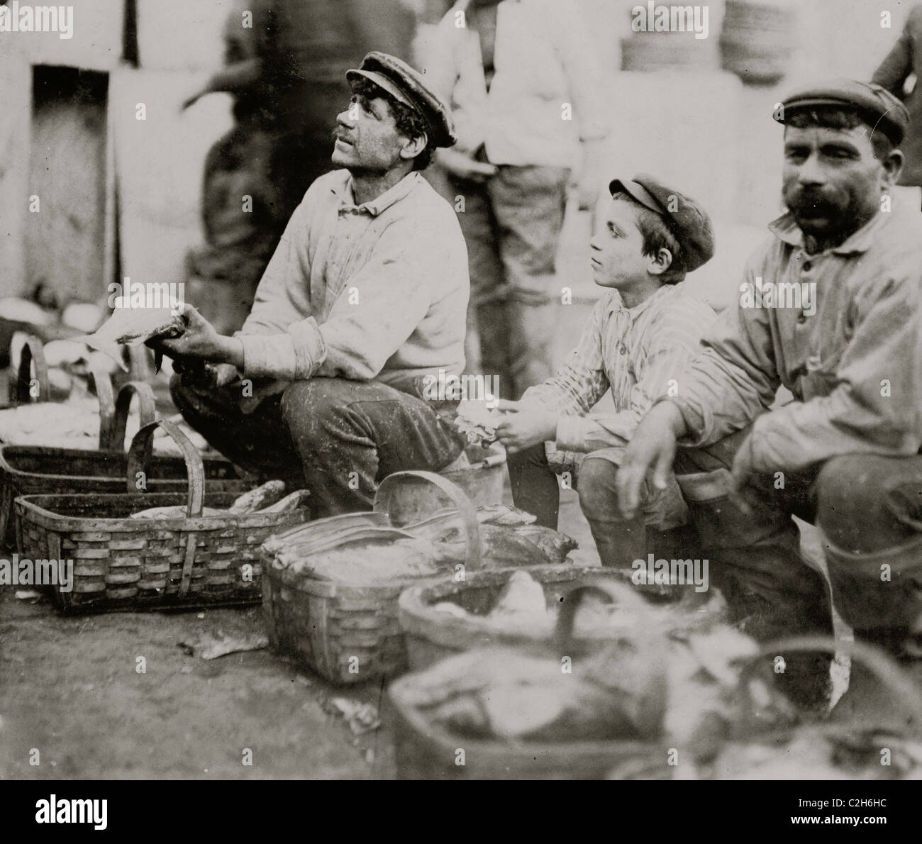A Typical Fisher Boy at "T" Wharf selling fish with Dad Stock Photo - Alamy