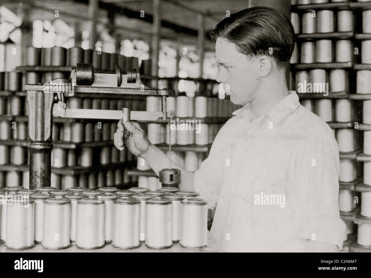 Young Boy Weighs Spools of Silk Thread Stock Photo - Alamy