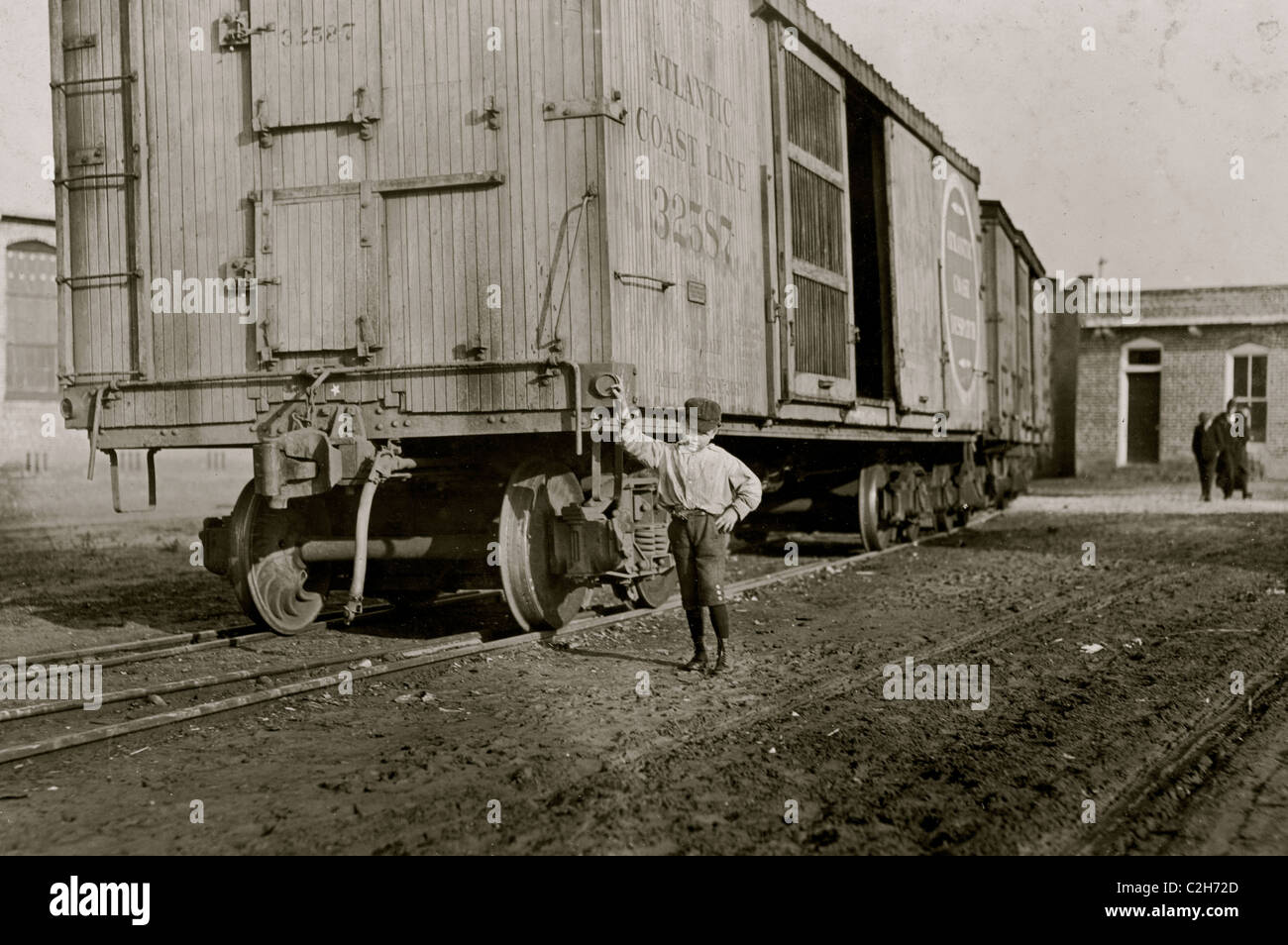 Boy beside a boxcar at the Mill Stock Photo - Alamy
