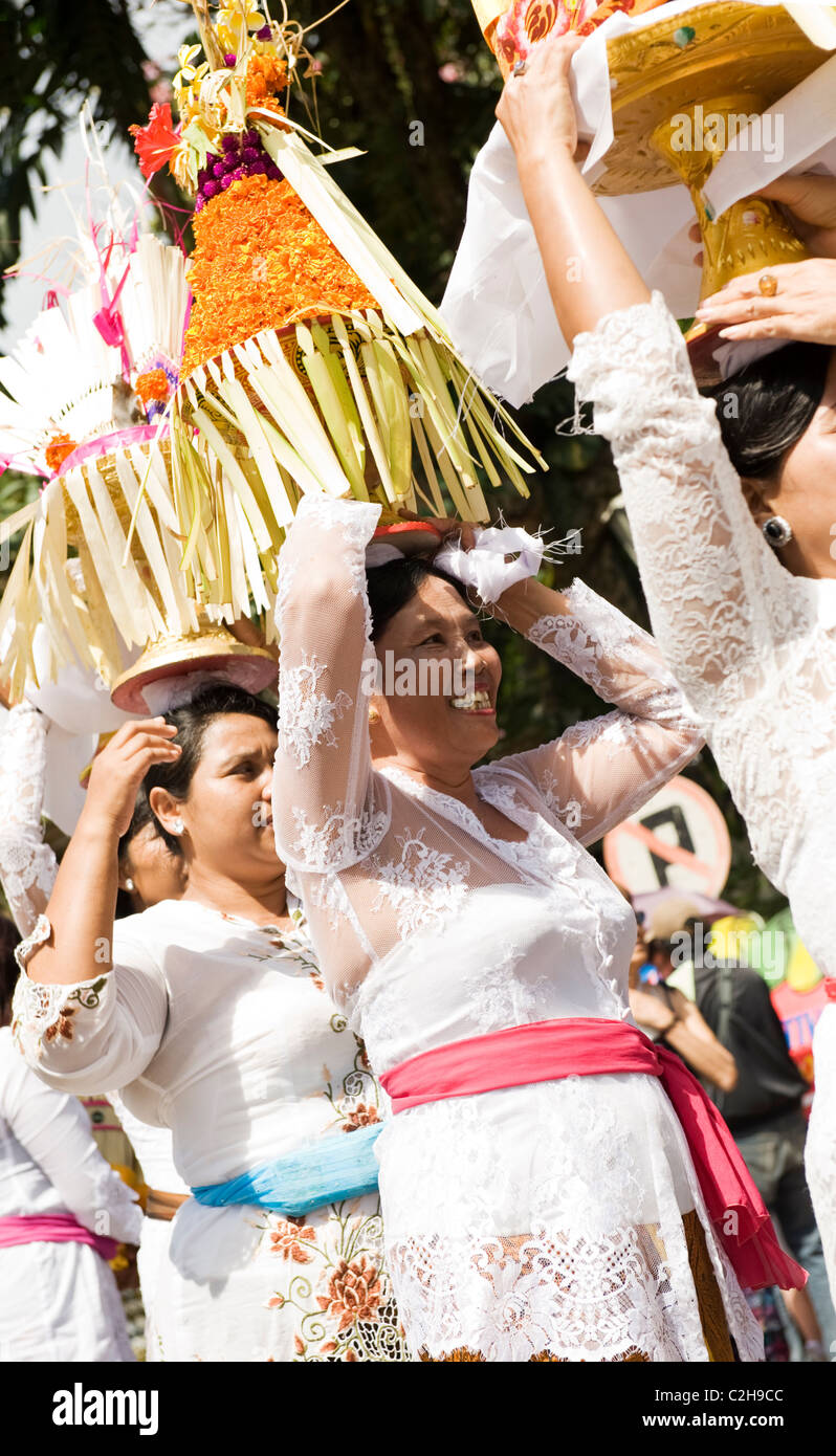 Offerings are carried as part of a religious parade through the ...