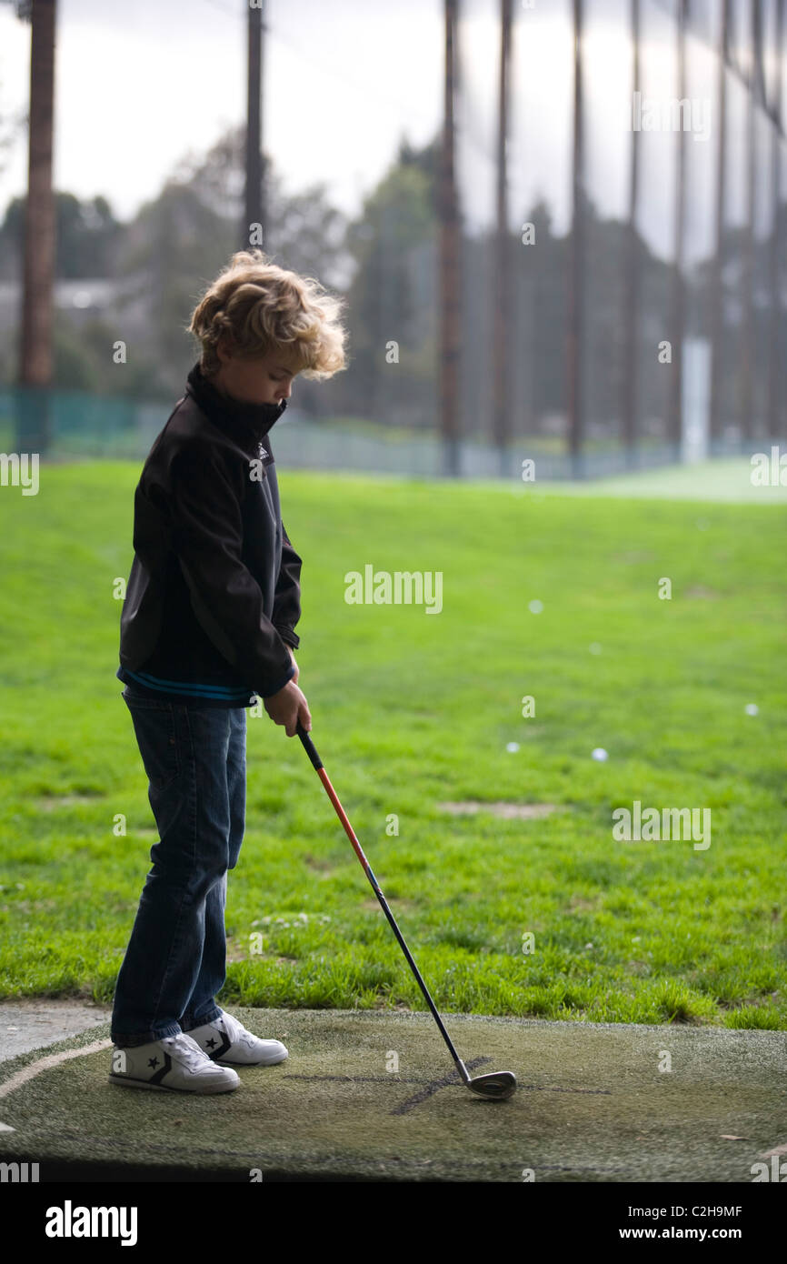 Young boy golfing Stock Photo - Alamy