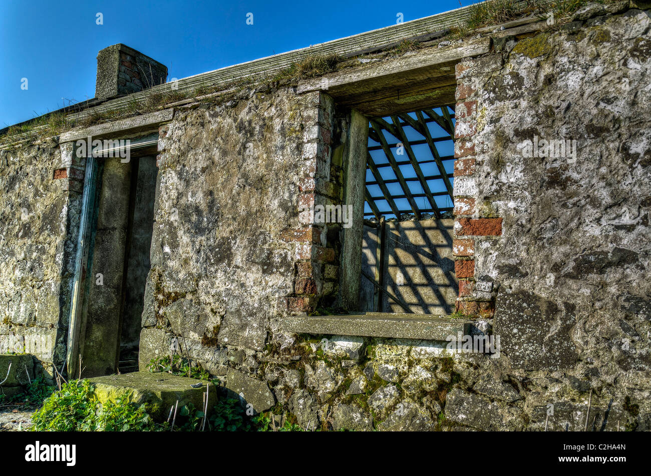 Derelict, run-down, cottage with blue sky background Stock Photo - Alamy