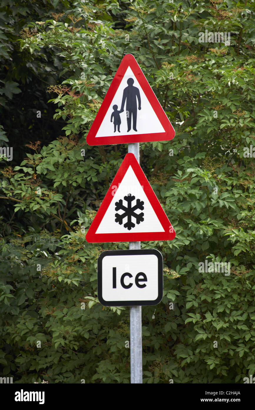 Road signs advising of Ice and caution pedestrians ahead - triangular ...