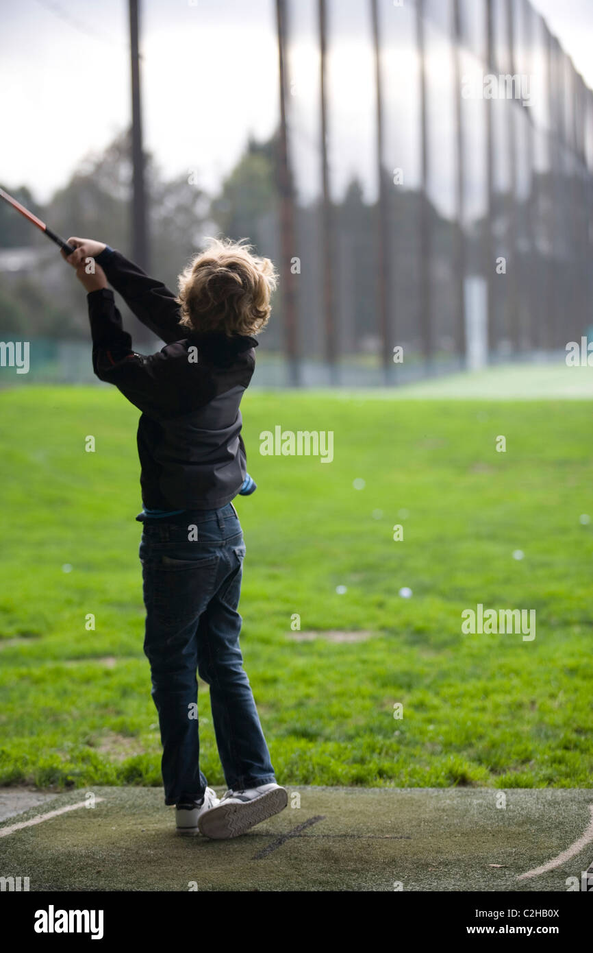Young boy golfing Stock Photo - Alamy