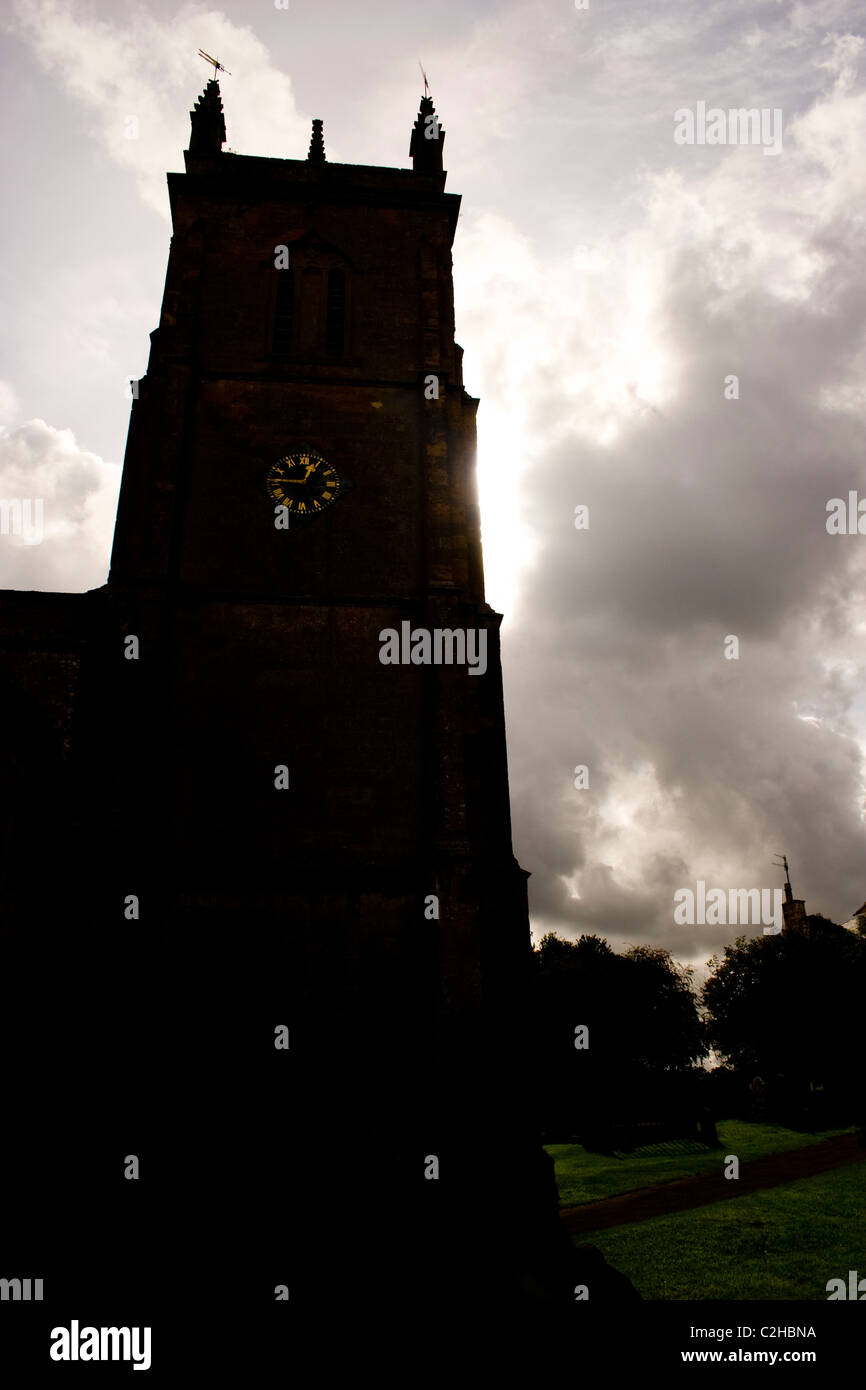 church tower clock silhouette sun cloud dark tall look up black outline ...