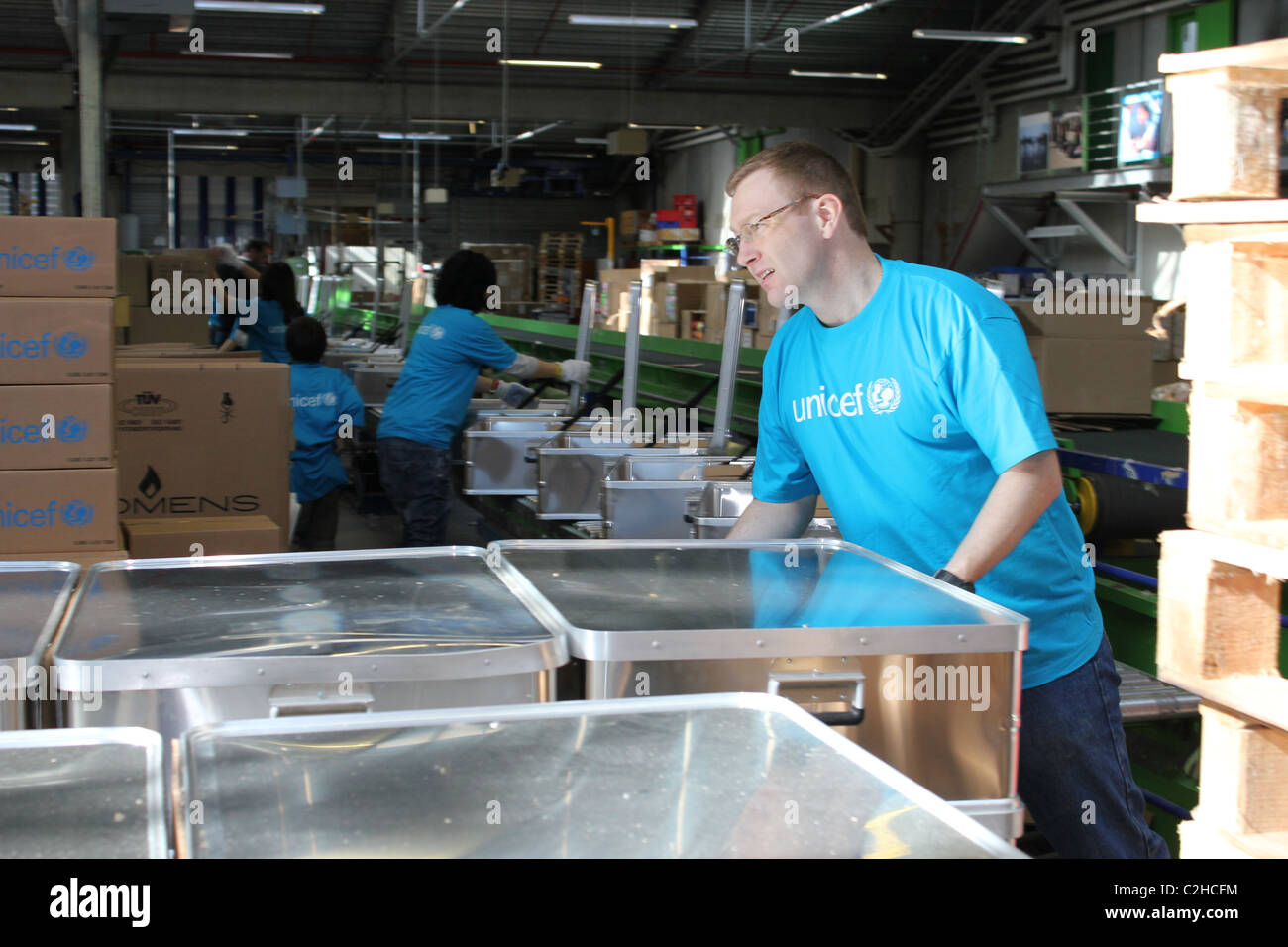 Volunteers packing aid kits in Unicef Supply Division in Copenhagen ...