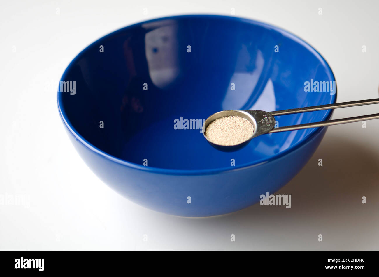 Adding yeast to the bowl Stock Photo - Alamy