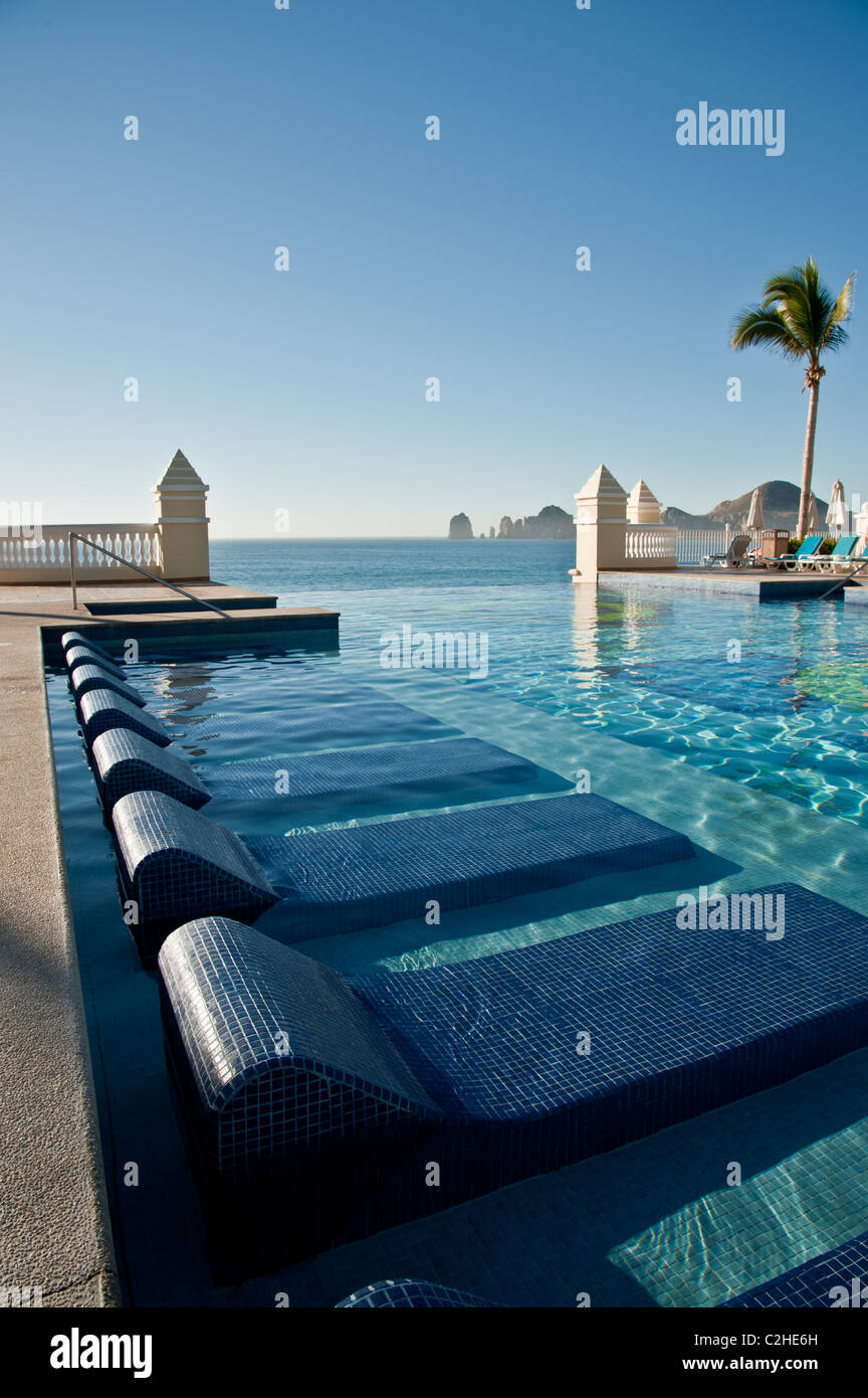A swimming pool at a tropical resort by the ocean Stock Photo - Alamy