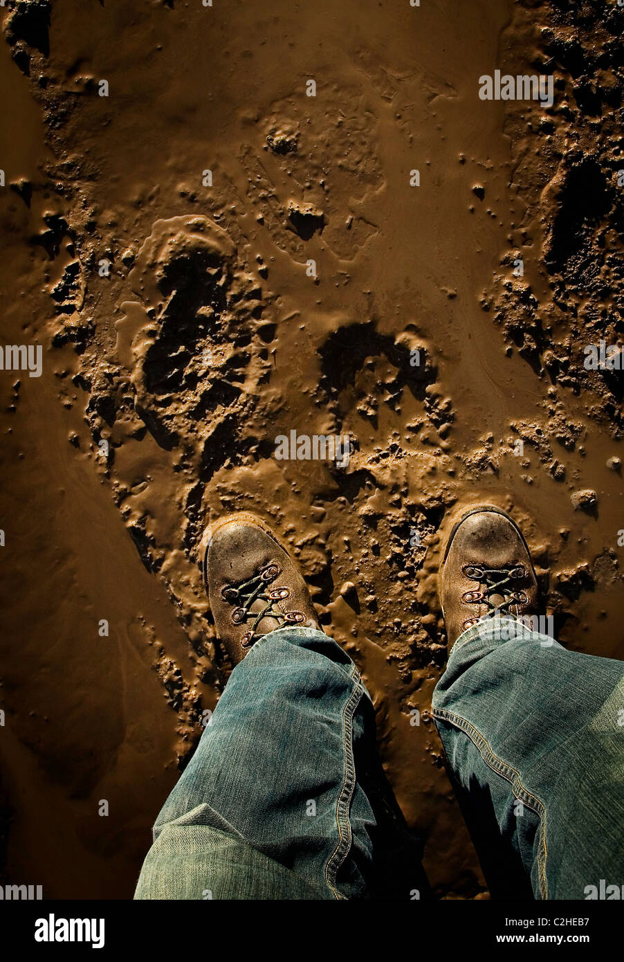 Low Section Of Person Standing In Mud Stock Photo - Alamy