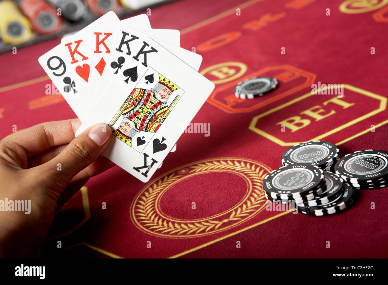 Image of five game cards in hands with black chips near by Stock Photo ...