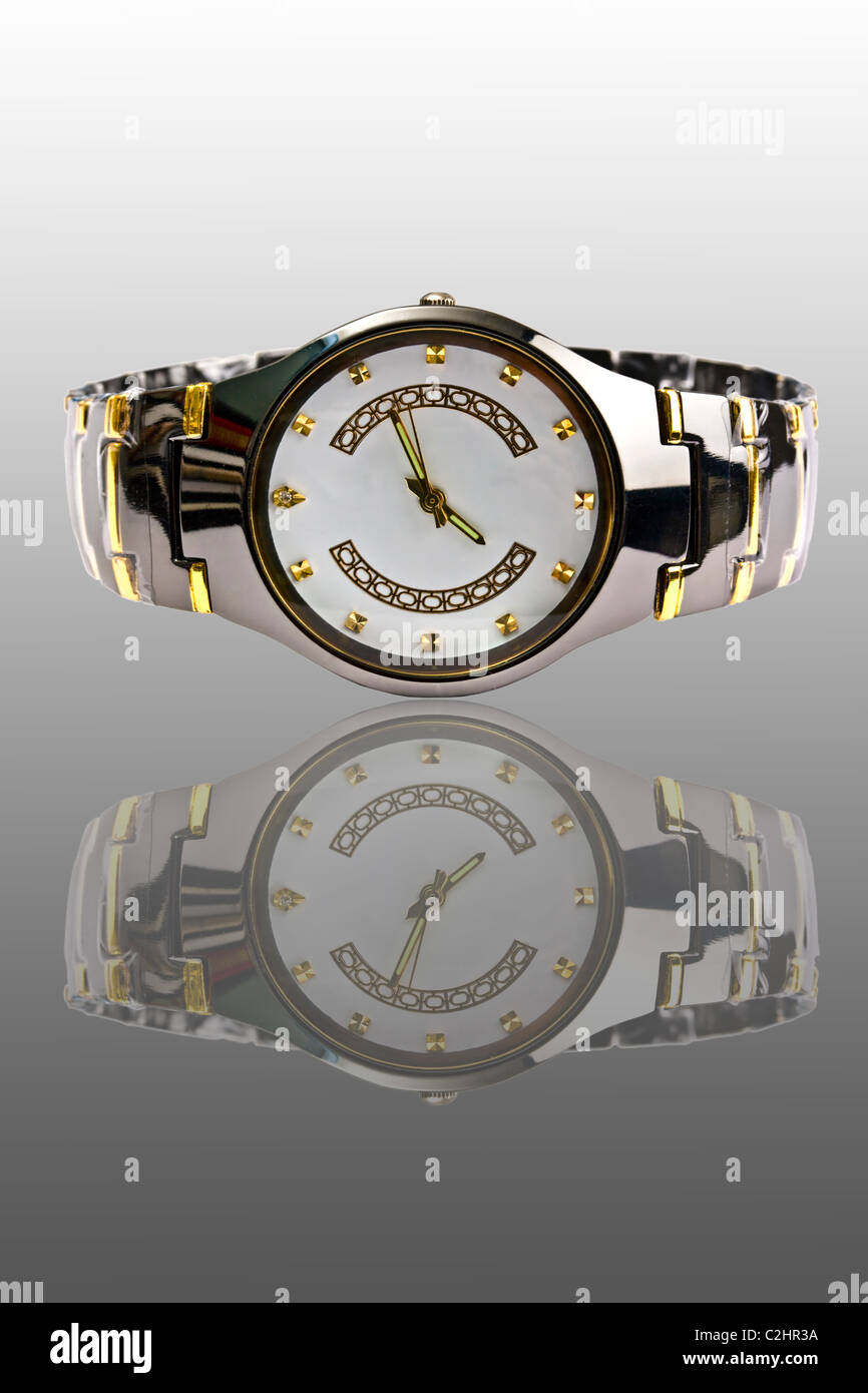Fashion watch and reflection on light background Stock Photo - Alamy