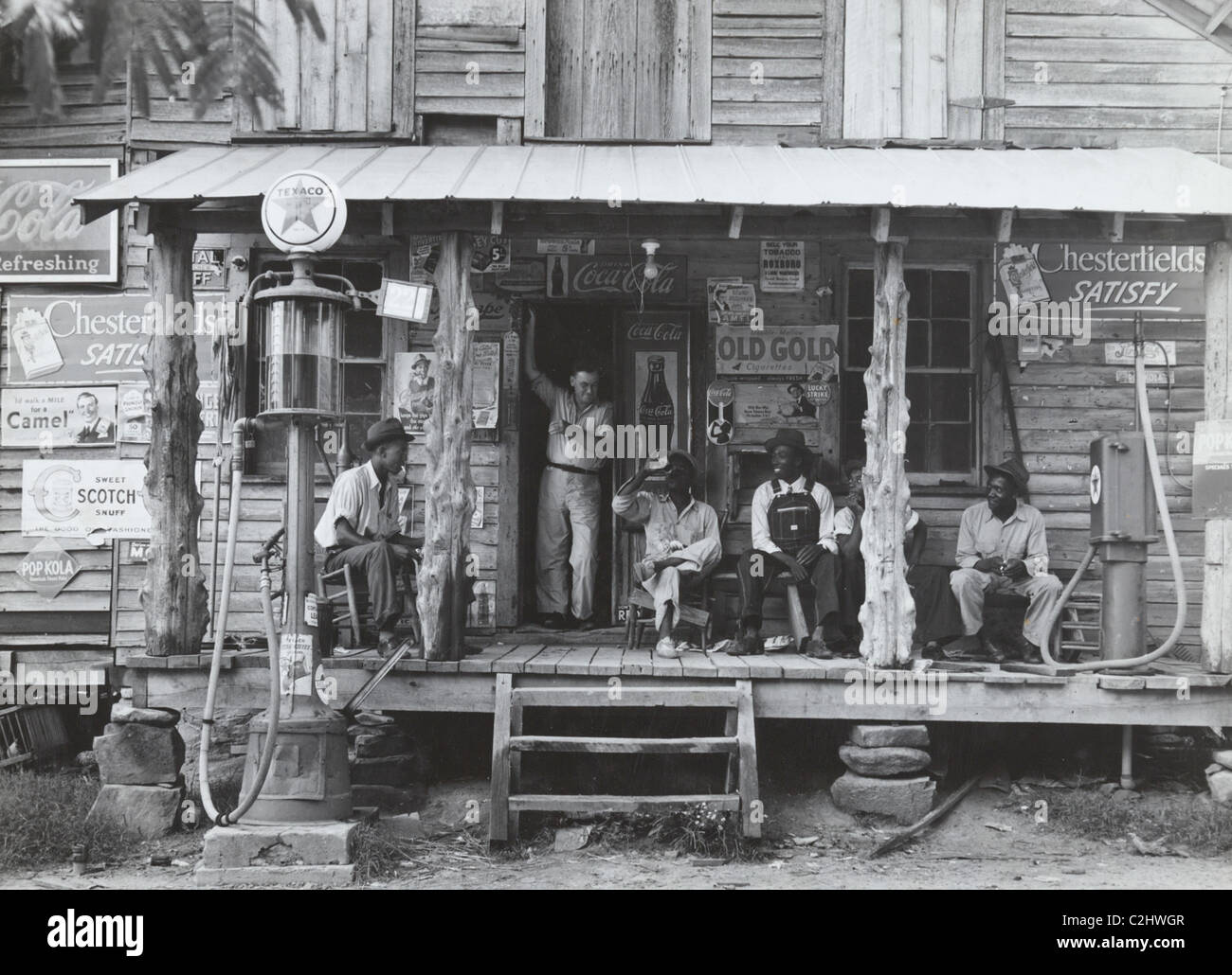 African American and a white store owner on the Porch of a country ...
