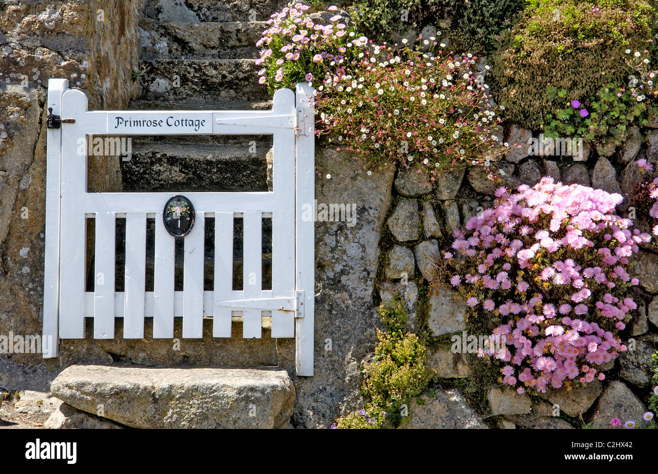 A cottage front garden gate at Mousehole village in Cornwall, England ...