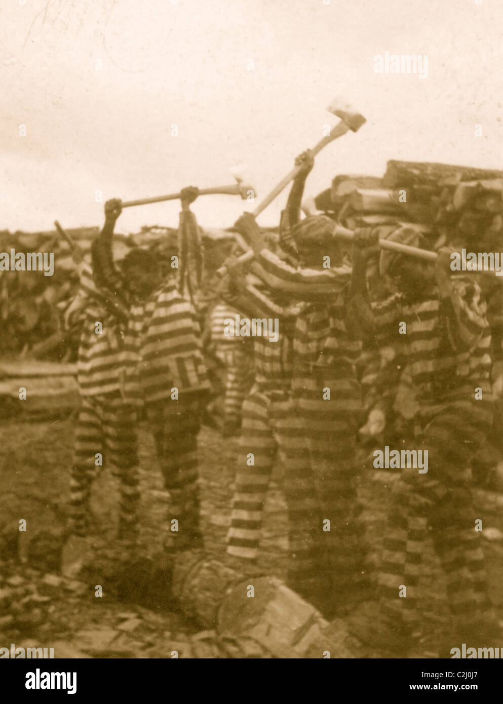 African American convicts working with axes, watchtower in background ...