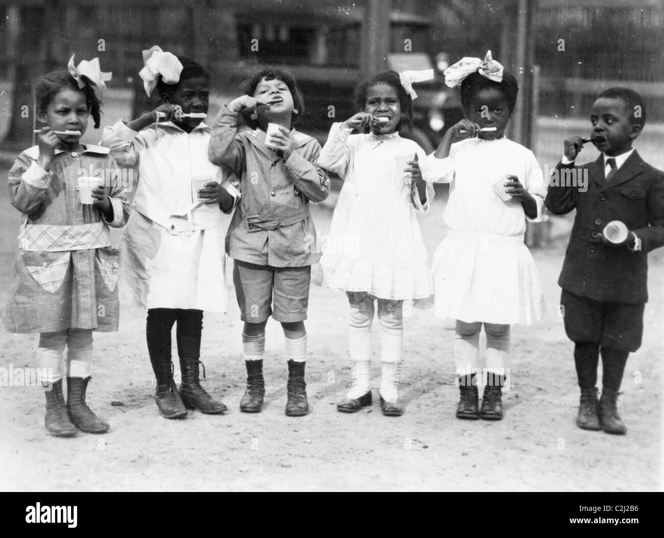 Six children brushing their teeth outside of school Stock Photo - Alamy