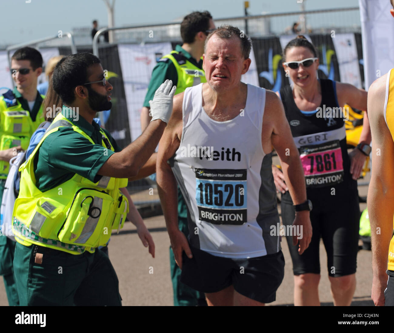 A runner being helped by a medic after completing the Brighton Marathon ...