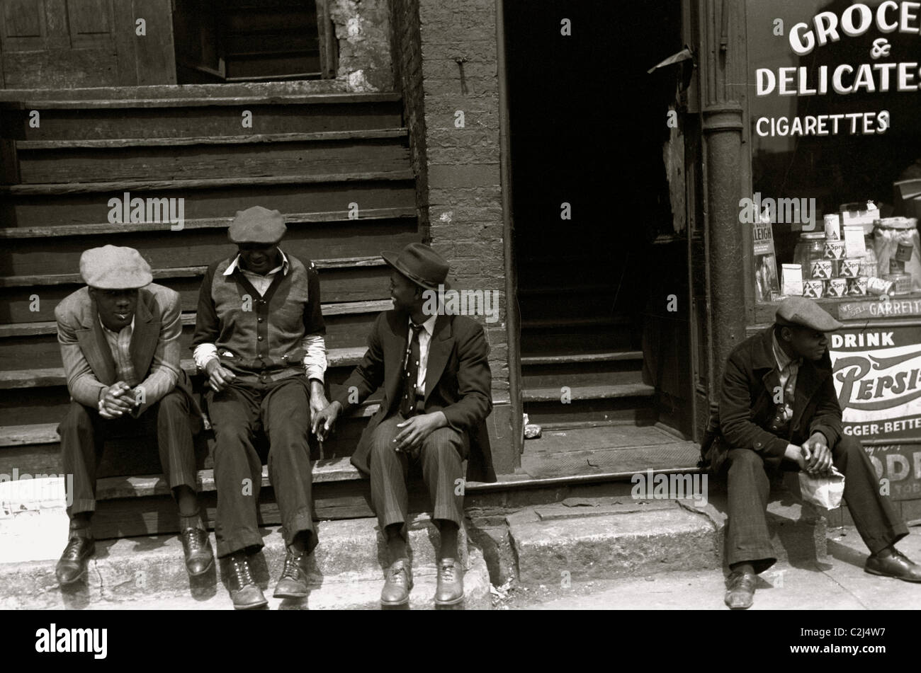 African American congregate on the steps next to a Delicatessen Stock ...