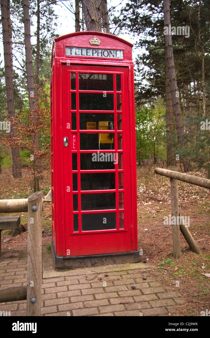 Old style red telephone box, housing yellow emergency phone, at ...