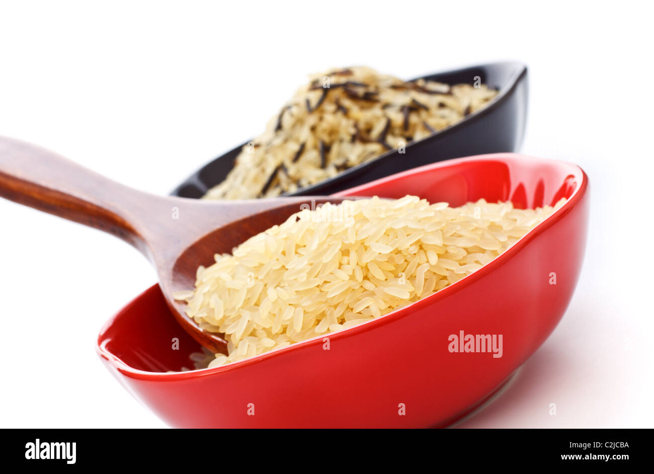 two bowls with rice and wooden spoon Stock Photo - Alamy