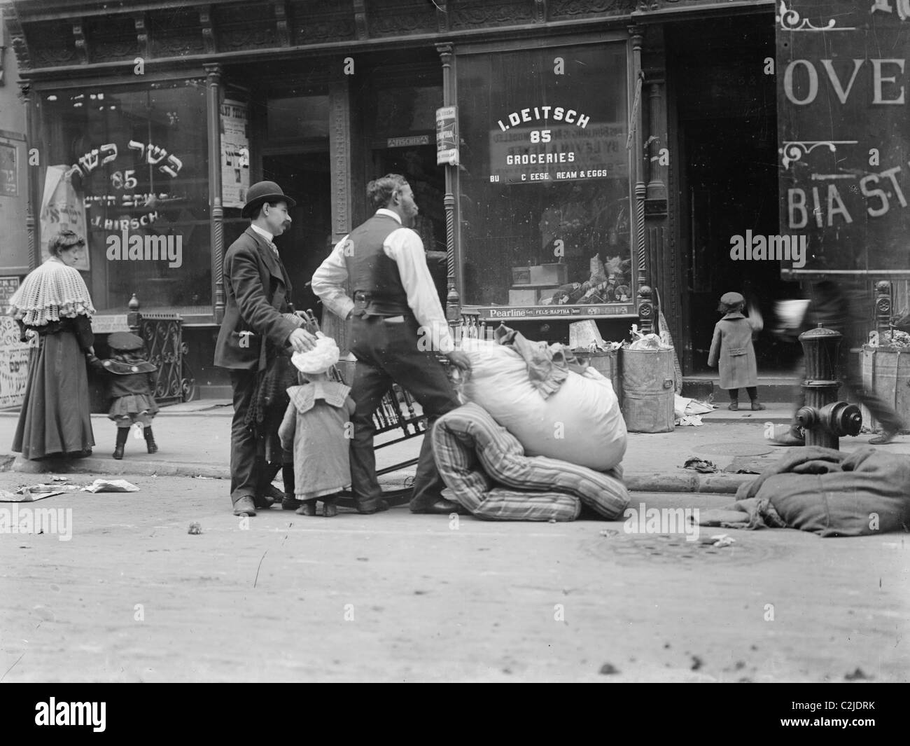 Outside of a Jewish Butcher Shop, Evictees look over their possessions ...
