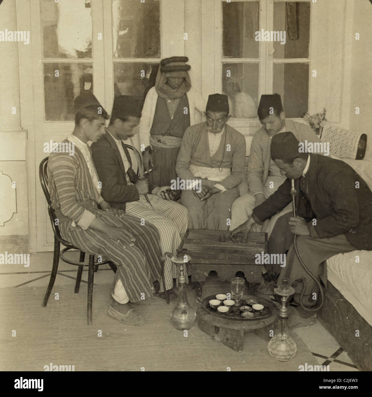 Turkish residents of Nazareth playing checkers and smoking narghiles ...