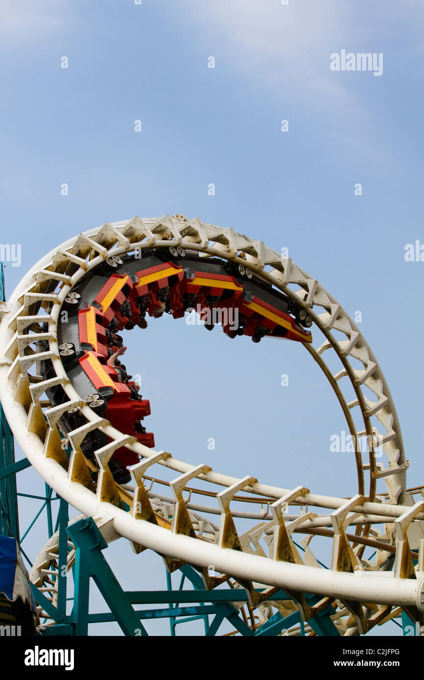 Riders enjoying exhilarating Roller Coaster, White knuckle Fairground ...