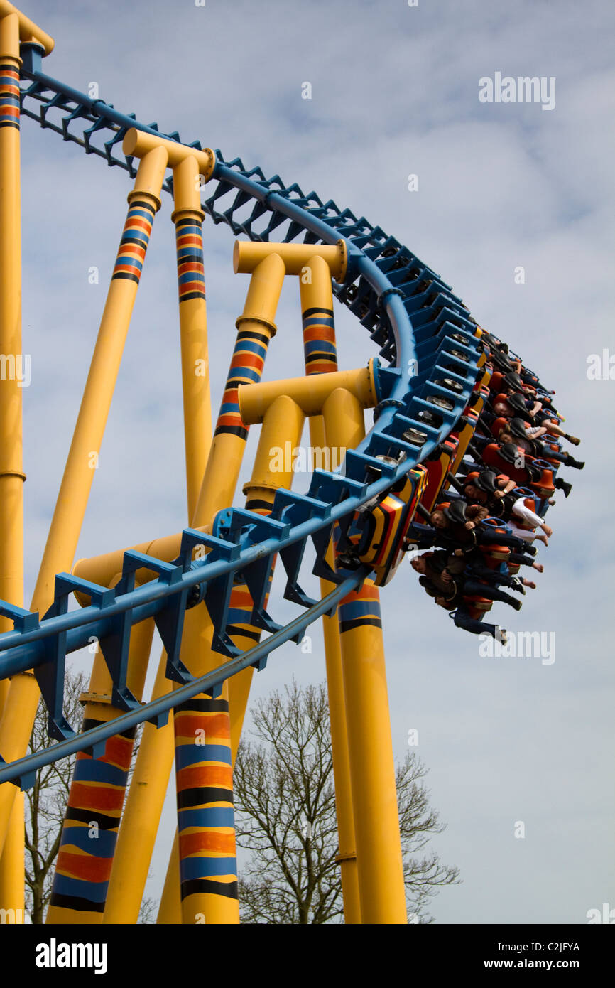 Riders enjoying exhilarating Roller Coaster, White knuckle Fairground ...