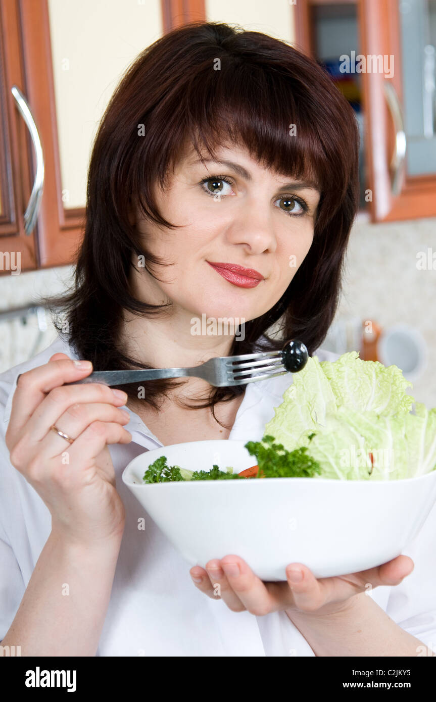Beautiful a woman to taste cooked the food Stock Photo - Alamy