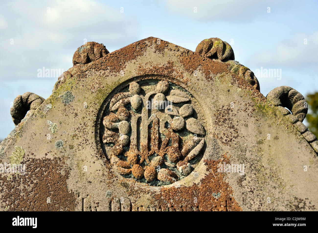 Detail of gravestone with foliage and IHS symbol. Church of Saint ...