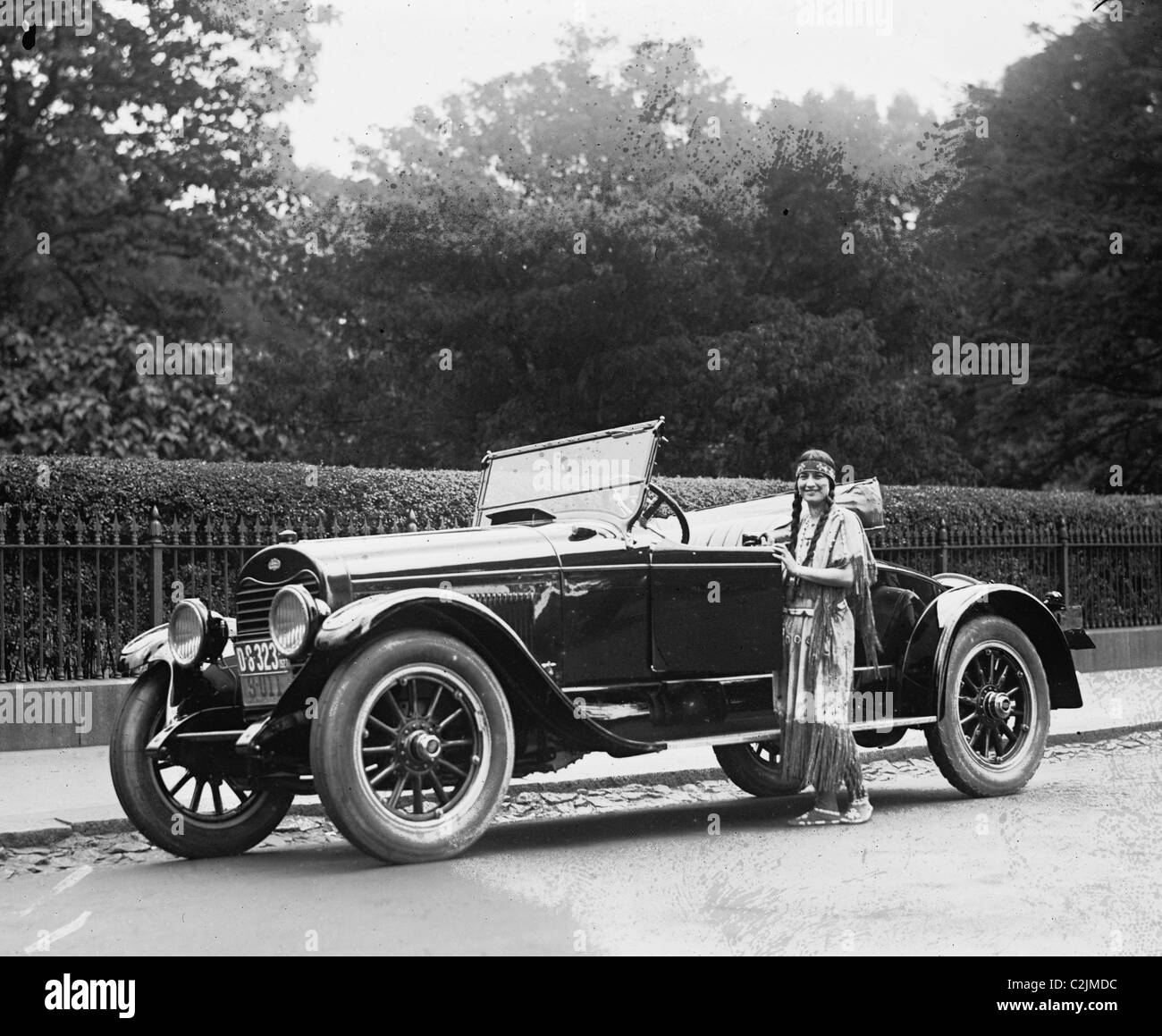 Woman wearing native American clothing next to automobile Stock Photo ...
