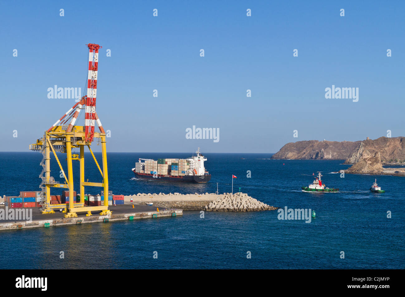 A container ship in port in the capital city of Muscat, Oman Stock ...