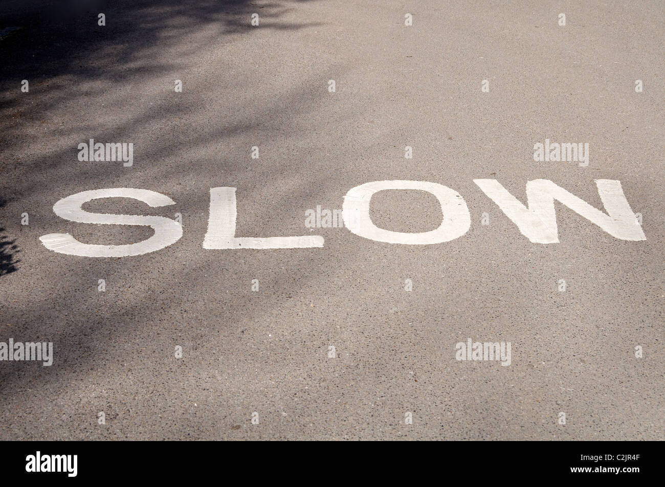 SLOW sign painted on a road surface Stock Photo - Alamy