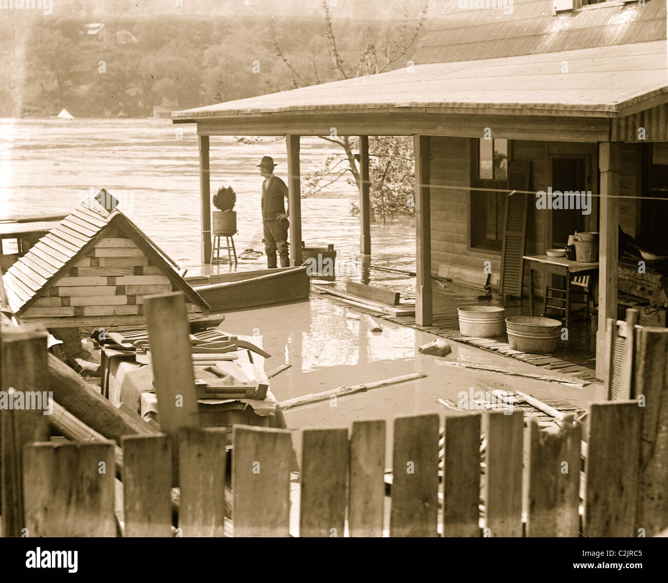 Flood with people looking out over a rover overflowing its banks Stock ...