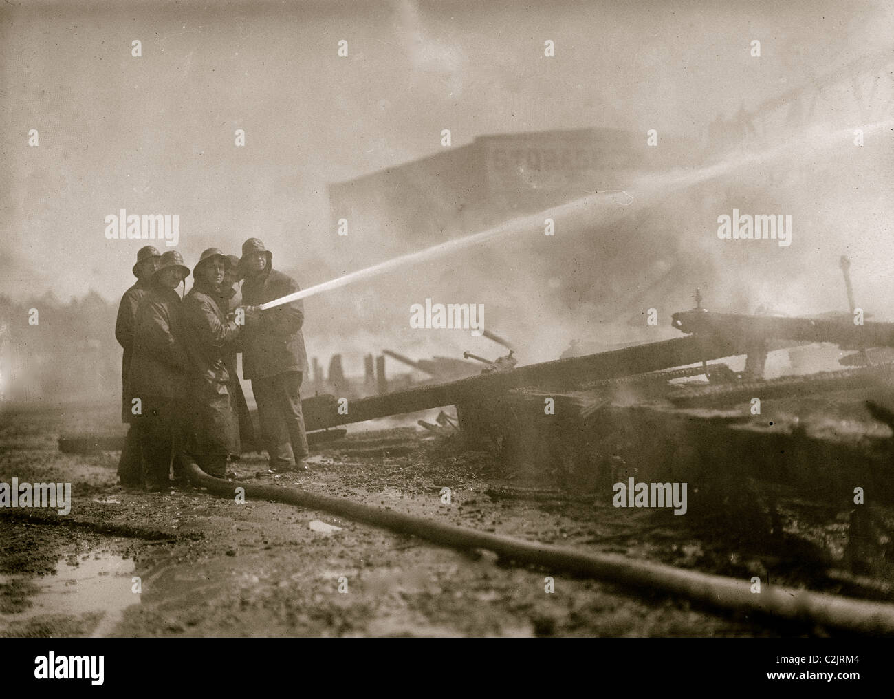 Firefighters, Firemen, Hoses Stock Photo - Alamy