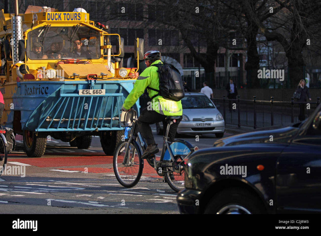 A man cycling on a Boris Bike amongst traffic in London Stock Photo - Alamy