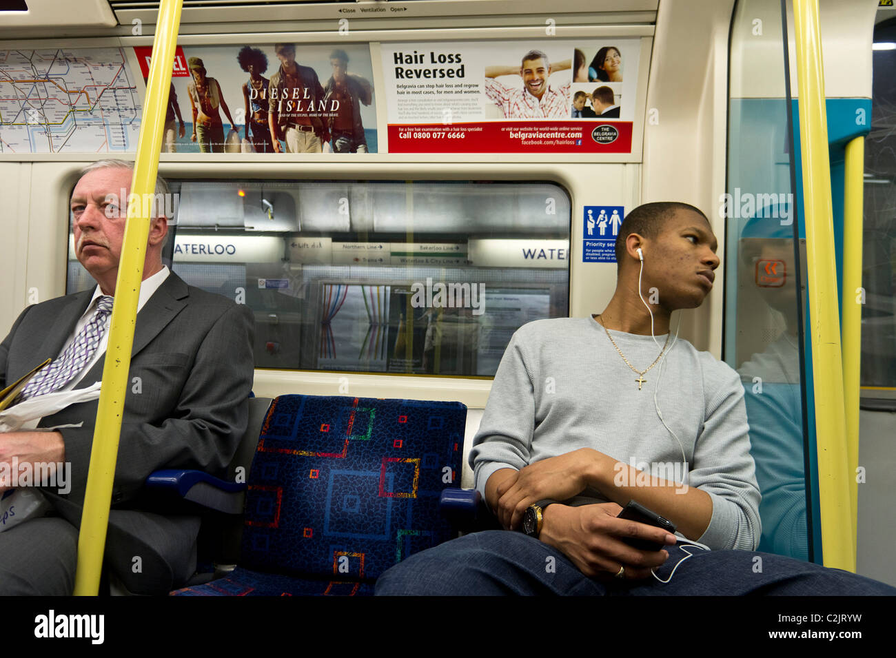 Commuters sit sitting tube train hi-res stock photography and images ...