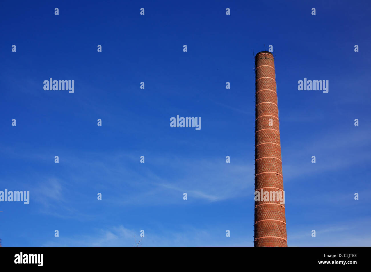 Tall red brick industrial smoke stack or chimney against blue sky Stock ...