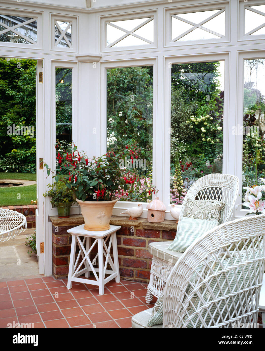 Traditional style wooden conservatory with half brick wall and ...