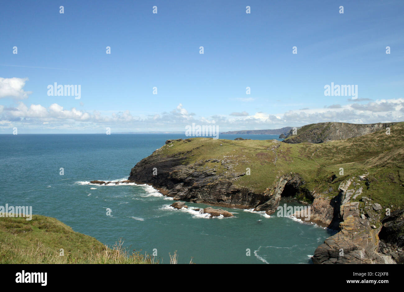 A cave in the cliff at Tintagel, Cornwall, below the castle Stock Photo ...