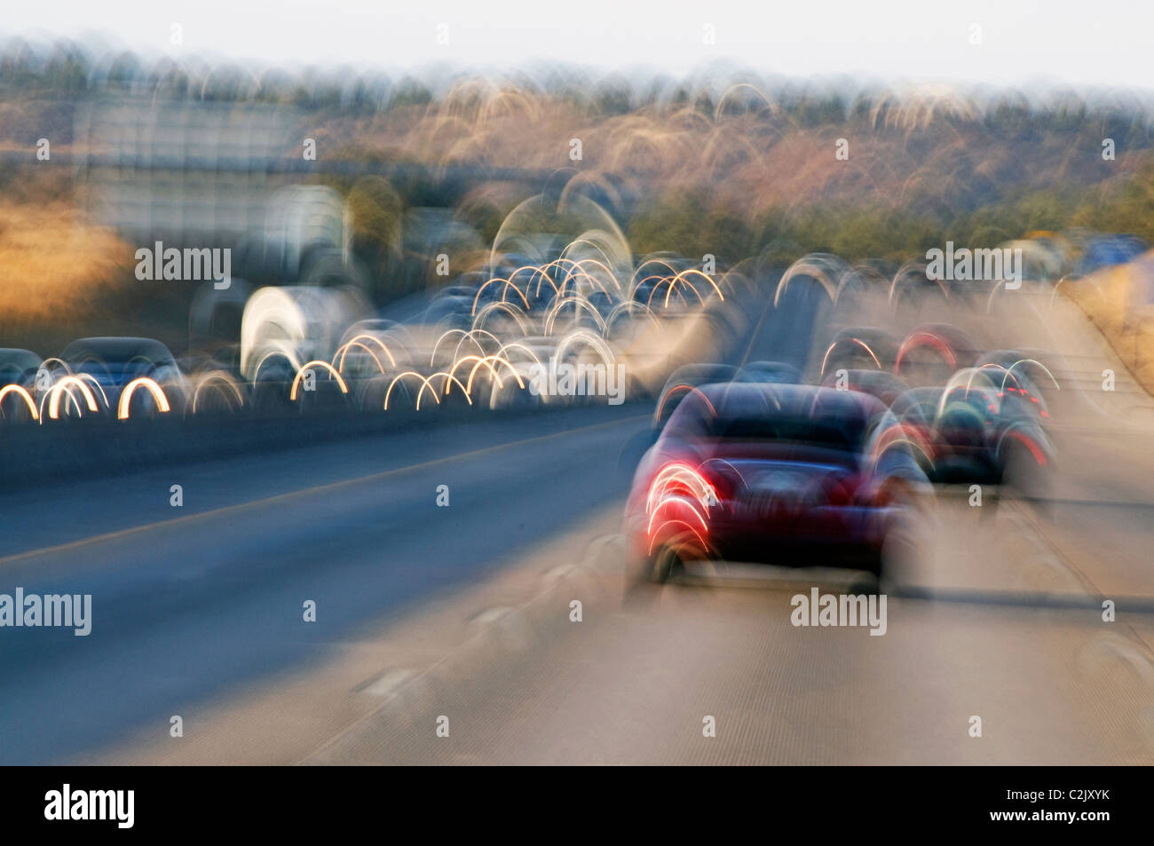 Speeding blurred automobiles on freeway Stock Photo - Alamy