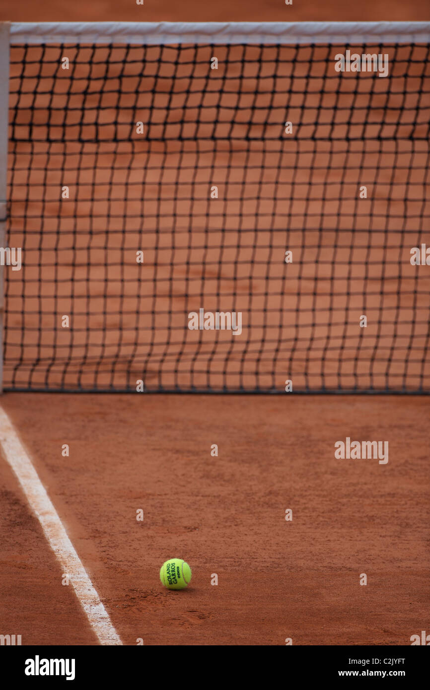 A tennis ball on the clay surface of Roland Garros before the start of ...