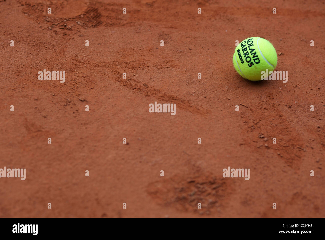A tennis ball on the clay surface of Roland Garros before the start of ...