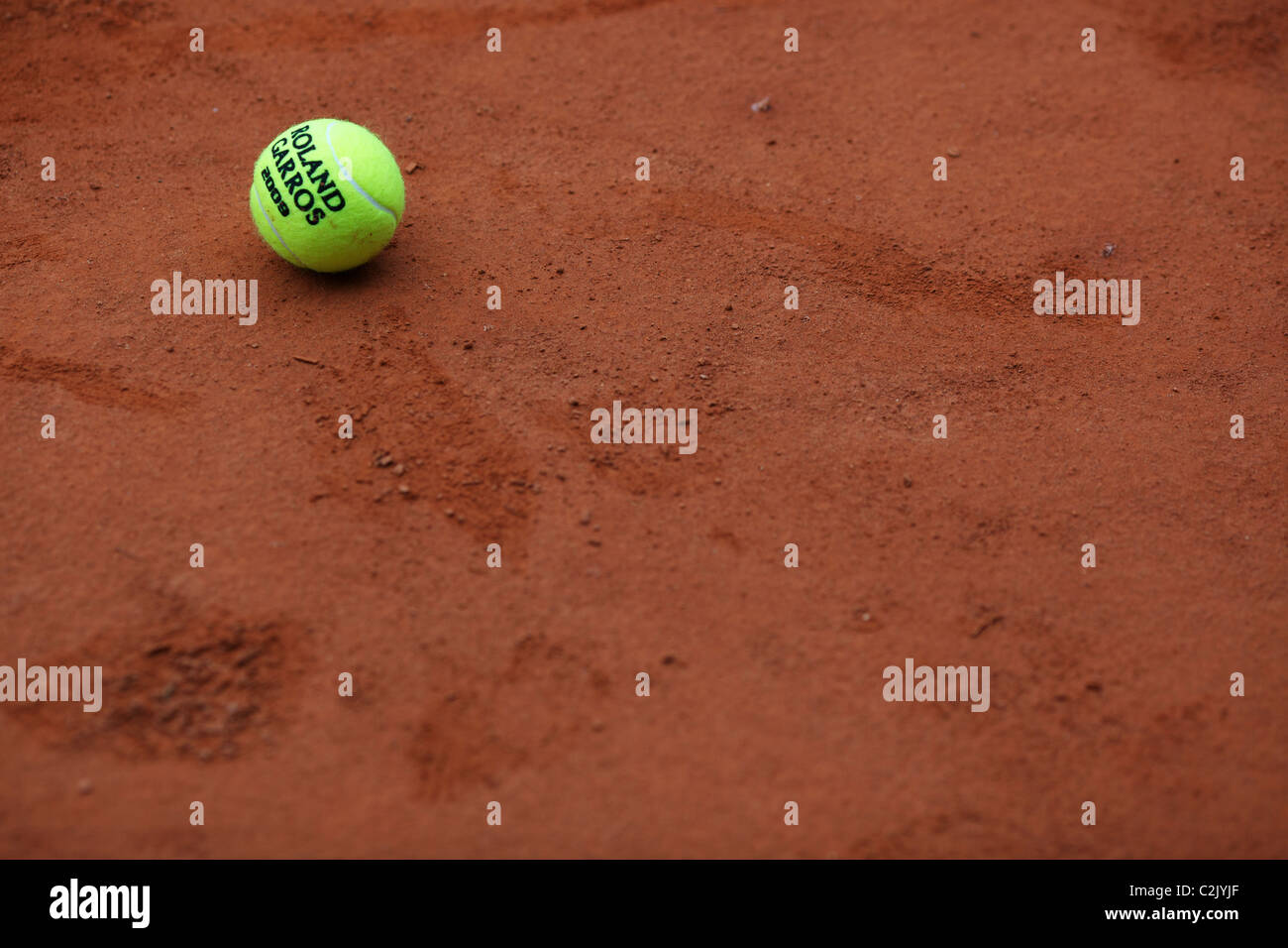 A tennis ball on the clay surface of Roland Garros before the start of ...