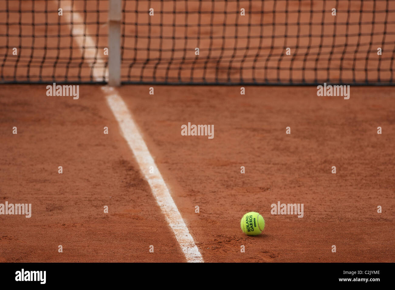 A tennis ball on the clay surface of Roland Garros before the start of ...