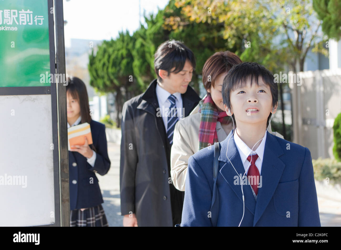 People Waiting at Bus Stop Stock Photo - Alamy