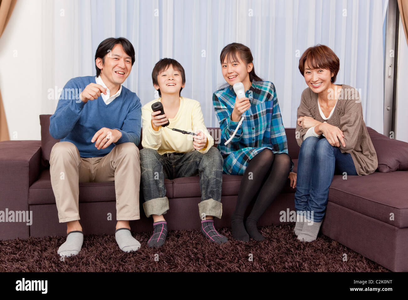 Family Playing Video Game Together Stock Photo - Alamy