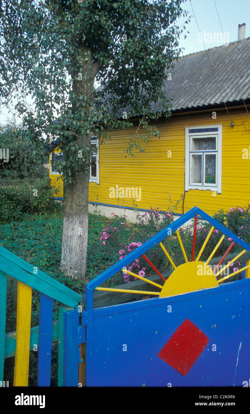 Colorful wooden house with fence gate in traditional belarusian village ...