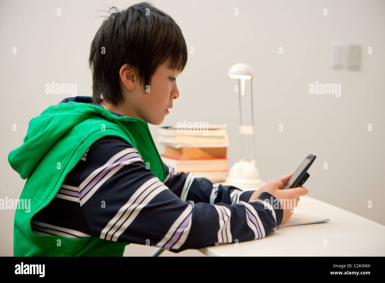 Boy Looking Cellular Phone Stock Photo - Alamy