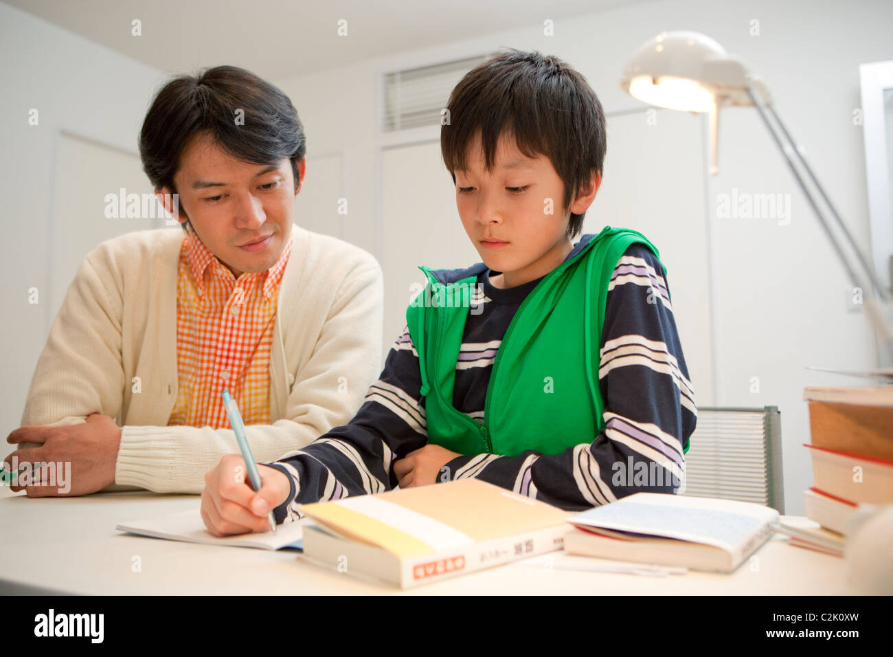 Father Looking Son Studying Stock Photo - Alamy